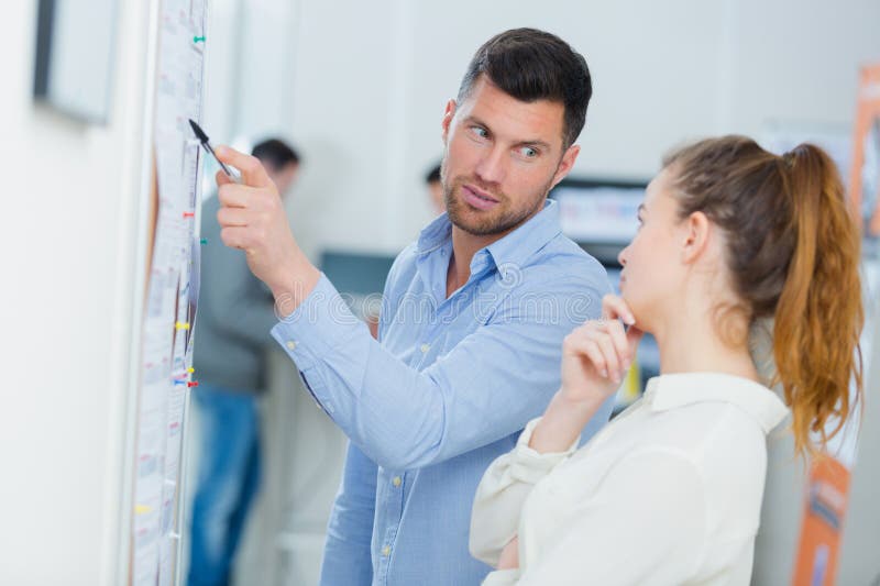 Teacher Showing Wall Notice To Apprentice Stock Image - Image of sticky ... Teacher Showing Wall Notice To Apprentice Stock Image - Image of sticky ...