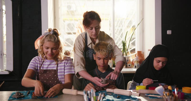 Teacher Shows Student Technique of Modeling Clay Element Stock Footage ...
