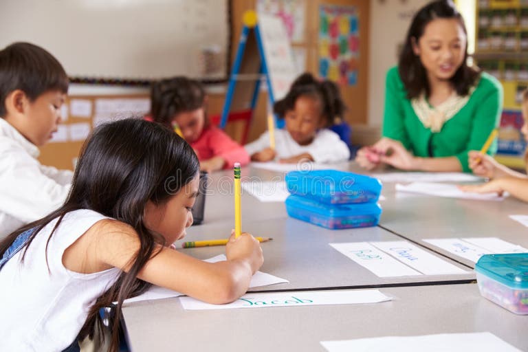 Teacher Sitting with Kids in Elementary School Lesson Stock Photo ...