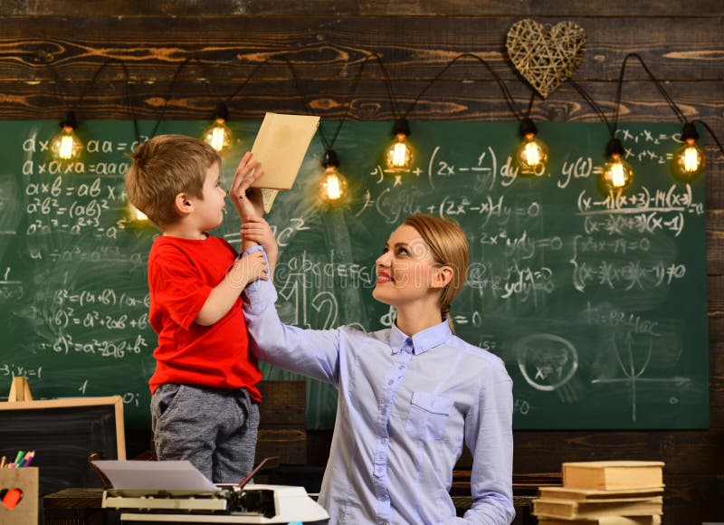 Teacher is Sitting at the Table in Classroom, Talented Coach during ...