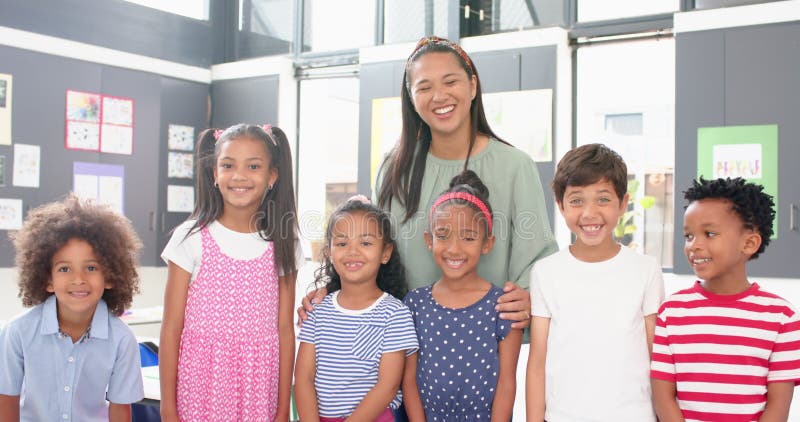 Teacher Smiling with Diverse Group of Students in Classroom at School ...
