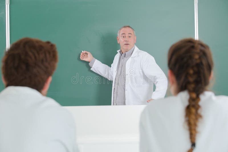 Teacher Standing in Front Board and Students in Classroom Stock Image ...