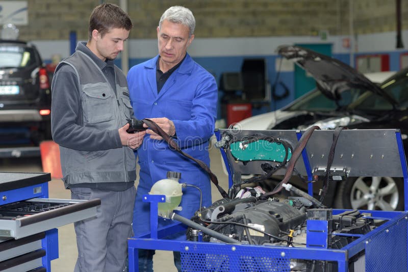 Teacher and Student in Auto Mechanics Training Class Stock Image ...