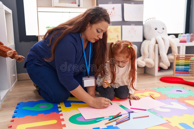 Teacher and Student Drawing on Paper Sitting on Floor at Kindergarten ...