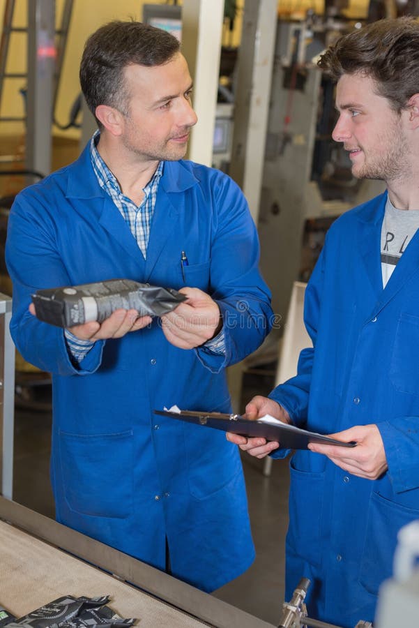 Teacher with Student in Mechanics Class Stock Photo - Image of ...