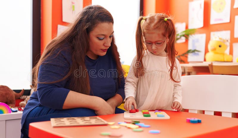 Teacher and Student Playing Supermarket Game Sitting on Floor at ...