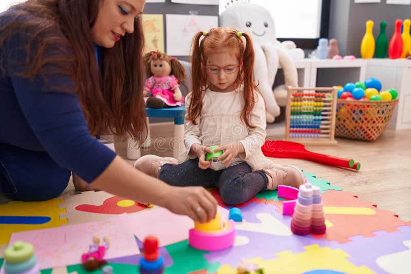 Teacher and Student Playing with Toys Sitting on Floor at Kindergarten ...