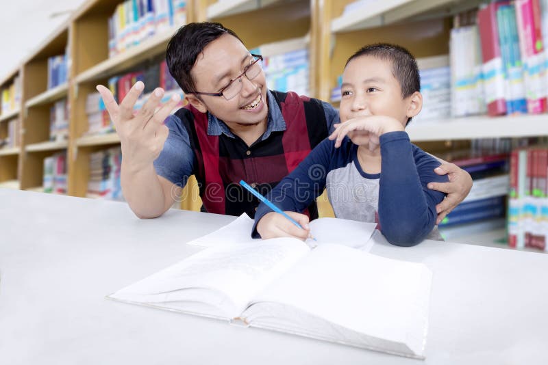 Teacher Holding Text Book Pointing To Student Stock Image - Image of ...