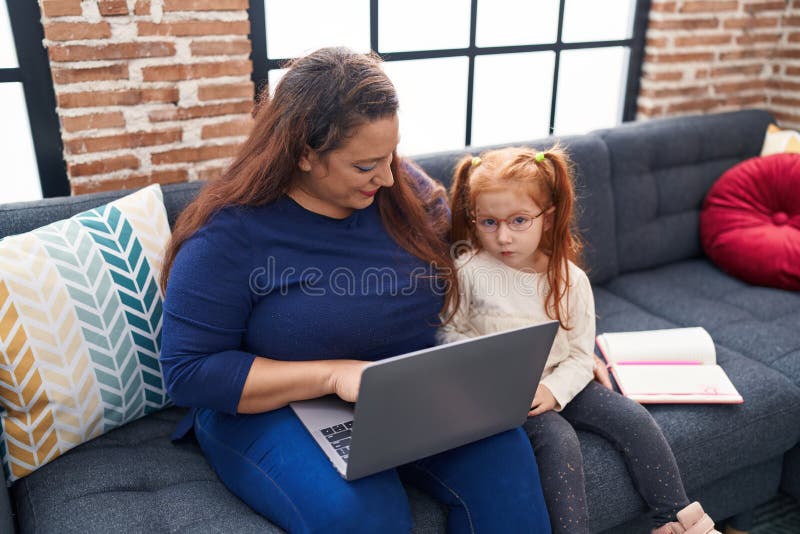 Teacher and Student Using Laptop Sitting on Sofa at Home Stock Photo ...