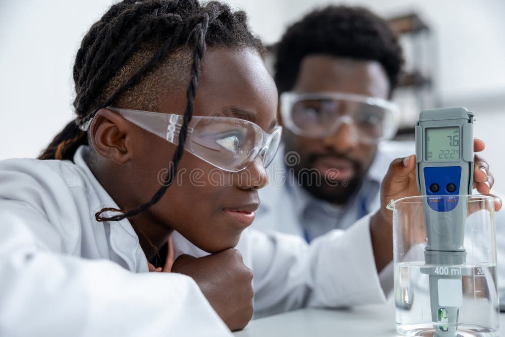 Teacher and Student Working in a School Laboratory and Looking Involved ...