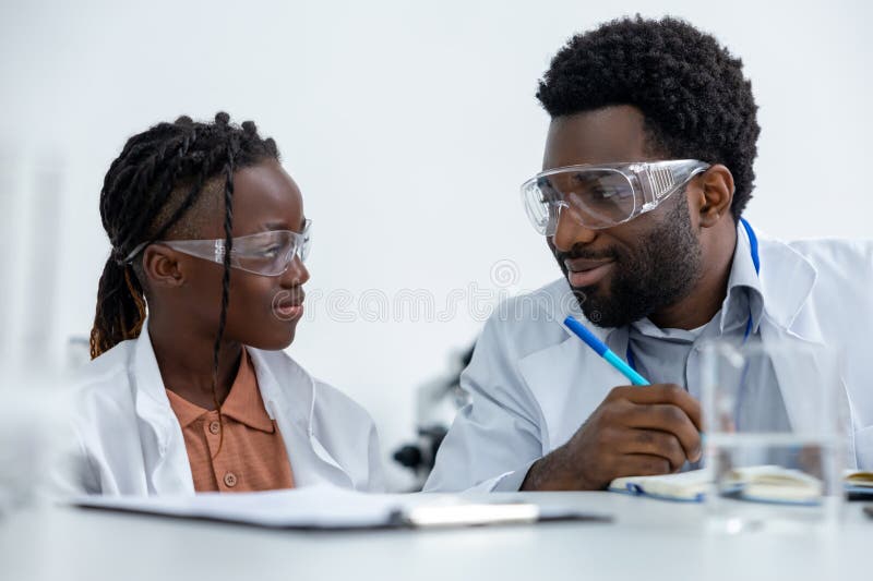 Teacher and Student Working in a School Laboratory and Looking Involved ...