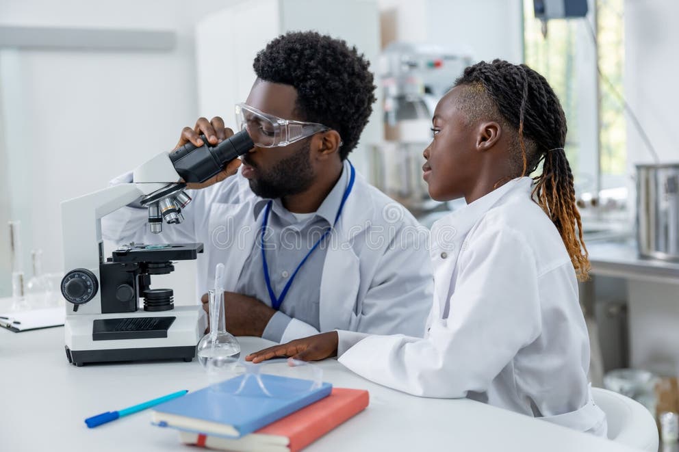 Teacher and Student Working in a School Laboratory and Looking Involved ...