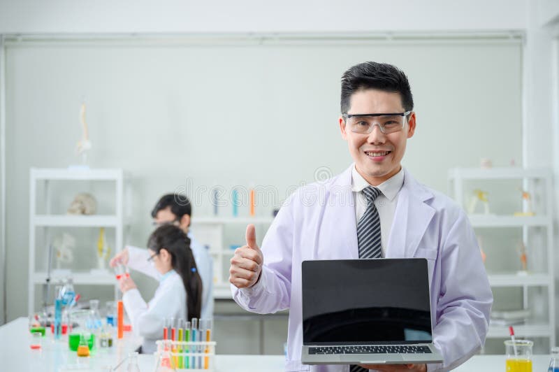 Teacher and Students are Looking at the Camera while Doing Science ...