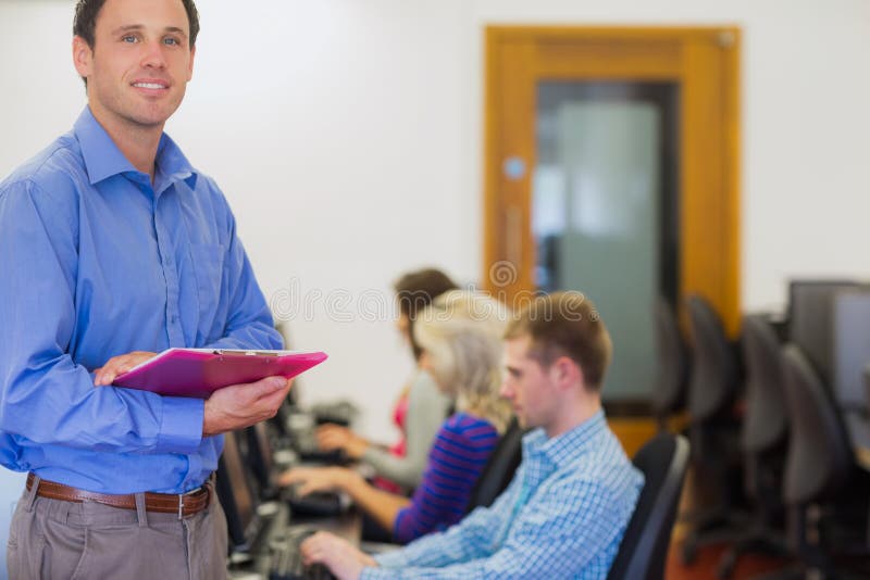 Teacher with Students Using Computers in Computer Room Stock Image ...