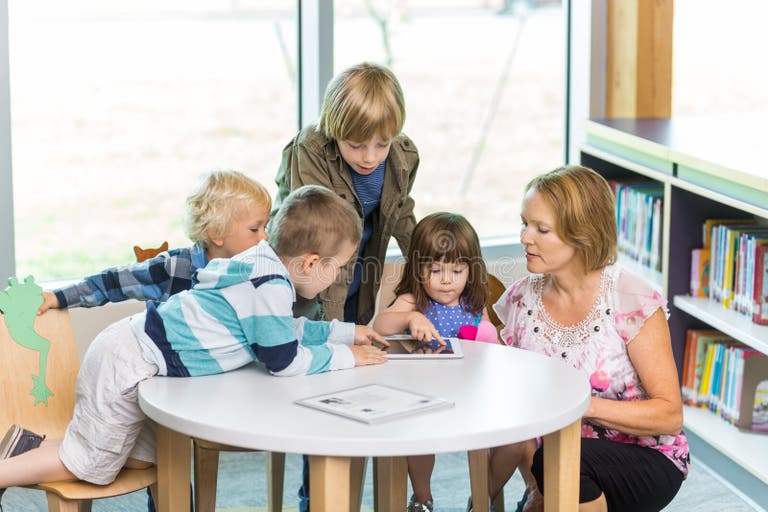 Teacher with Students Using Digital Tablets in Stock Photo - Image of ...