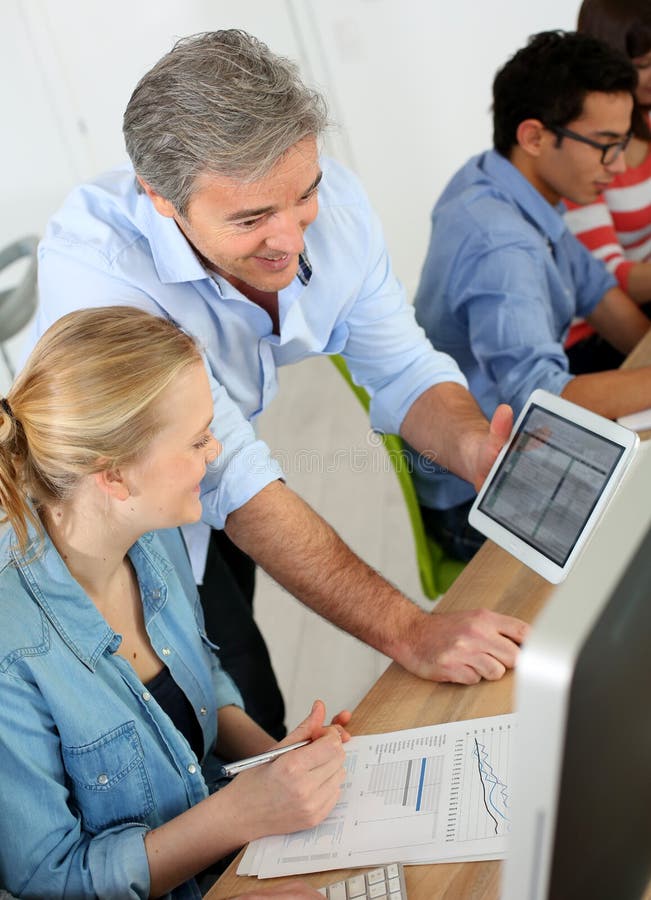 Teacher with Students Using Tablet in Class Stock Photo - Image of ...