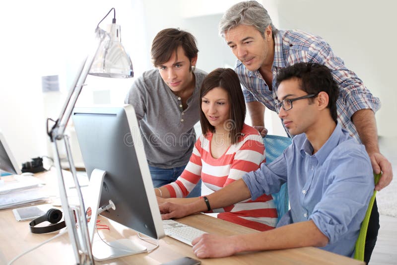 Teacher with Students Working on Computer Stock Image - Image of team ...