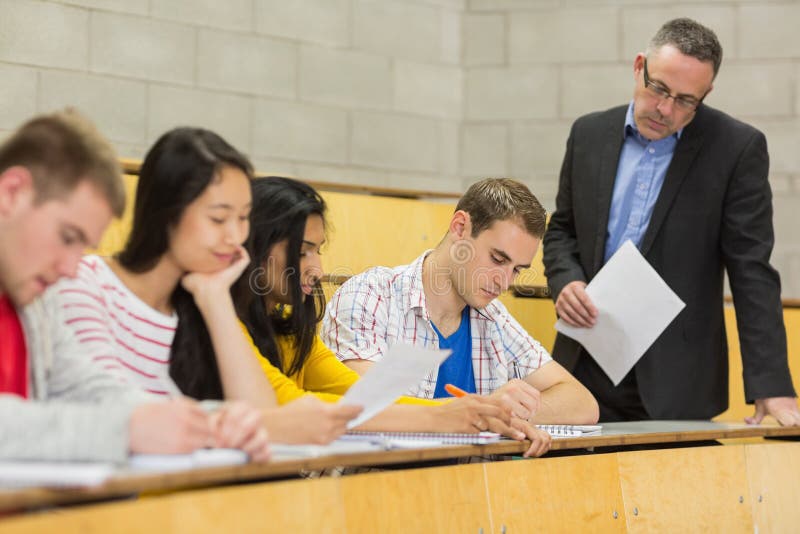 Teacher with Students Writing Notes in Lecture Hall Stock Image - Image ...