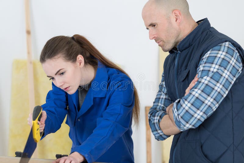 Teacher Supervising Woman Using Hand Saw Stock Photo - Image of human ...