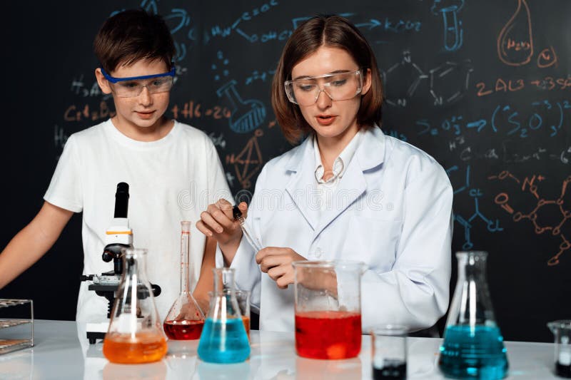 Teacher Support Schoolboy Mixing Solution in Laboratory STEM Class. Erudition. Stock Photo ...