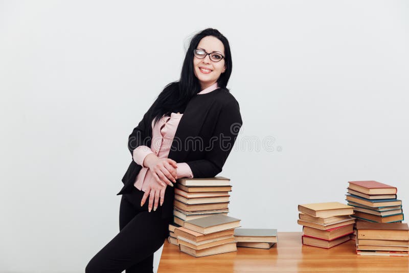 Female Teacher at the Table with Books for Studying at the University ...