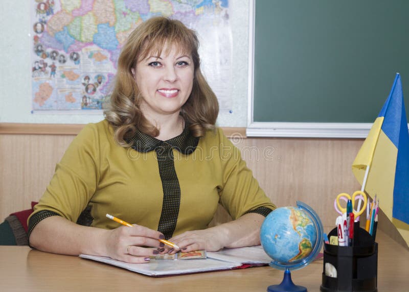 Teacher at the table stock image. Image of concept, holding - 65936095