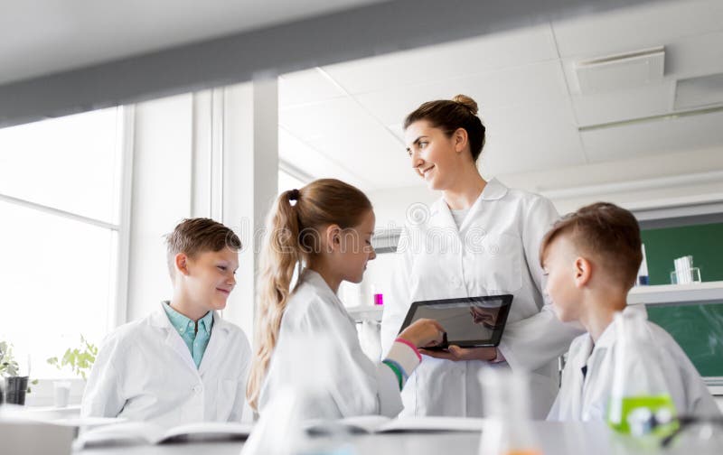 Teacher with Tablet Pc and Kids at Chemistry Class Stock Photo - Image of elementary, copyspace ...