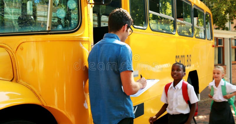 Teacher Taking Attendance while Student Entering in Bus Stock Video ...