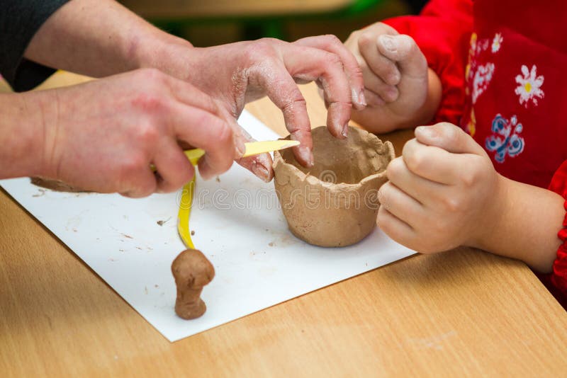 The Teacher Teaches the Student To Sculpt with Clay. Stock Photo ...
