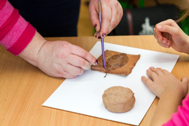 The Teacher Teaches the Student To Sculpt with Clay. Stock Photo ...
