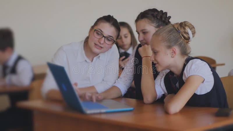 The Teacher Teaches Students To Work on a Laptop. Lesson in Computer ...