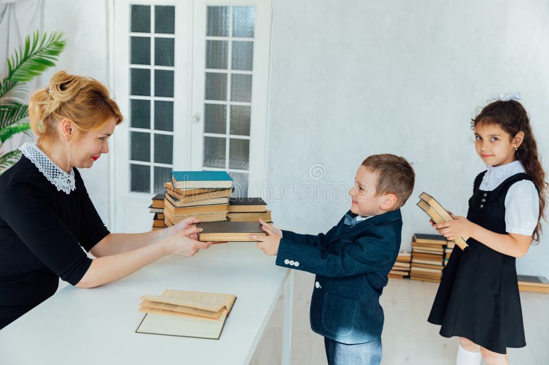 Teacher Teaching Boy and Girl in Blackboard Classroom at School Stock ...
