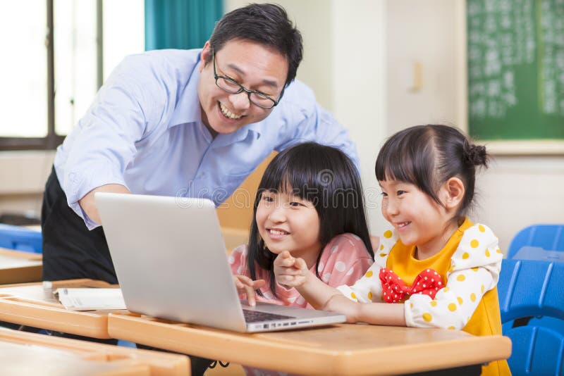 Teacher Teaching Children with a Laptop Stock Image - Image of ...