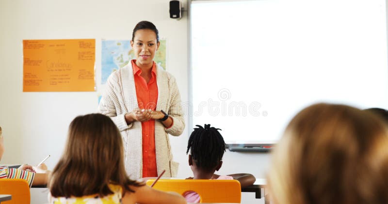 Teacher Teaching Students in Classroom. Kids Studying in Auditorium at ...