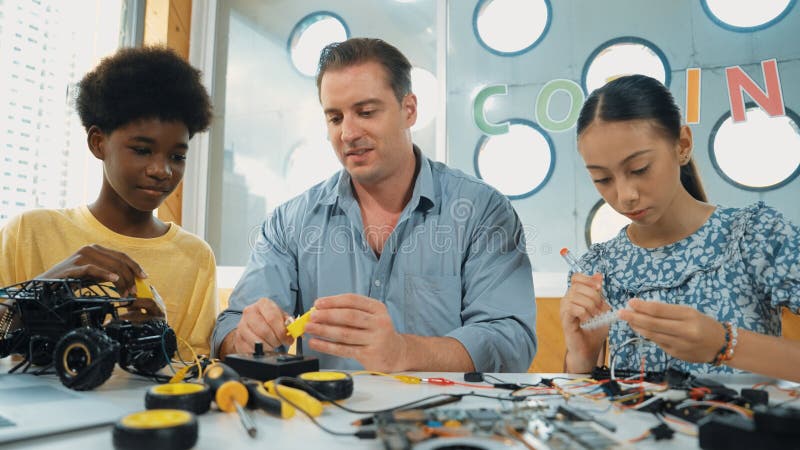 Teacher Teaching Diverse Students Fixing Car Model by Using Wire ...