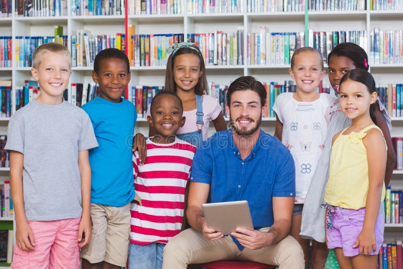 School Kids Sitting on Floor Using Digital Tablet in Library Stock ...
