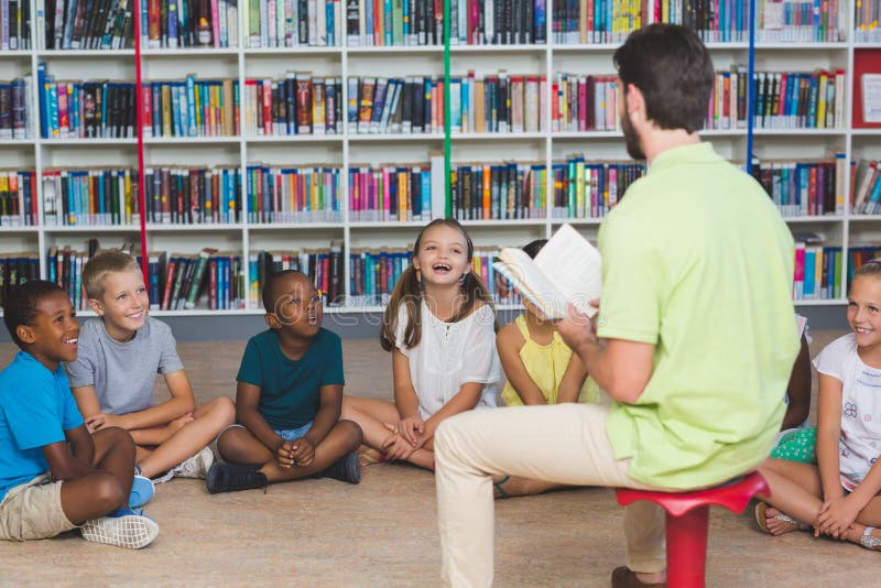 Teacher Teaching Kids in Library Stock Photo - Image of guidance ...