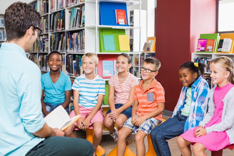 Teacher Teaching Kids in Library Stock Photo - Image of library ...