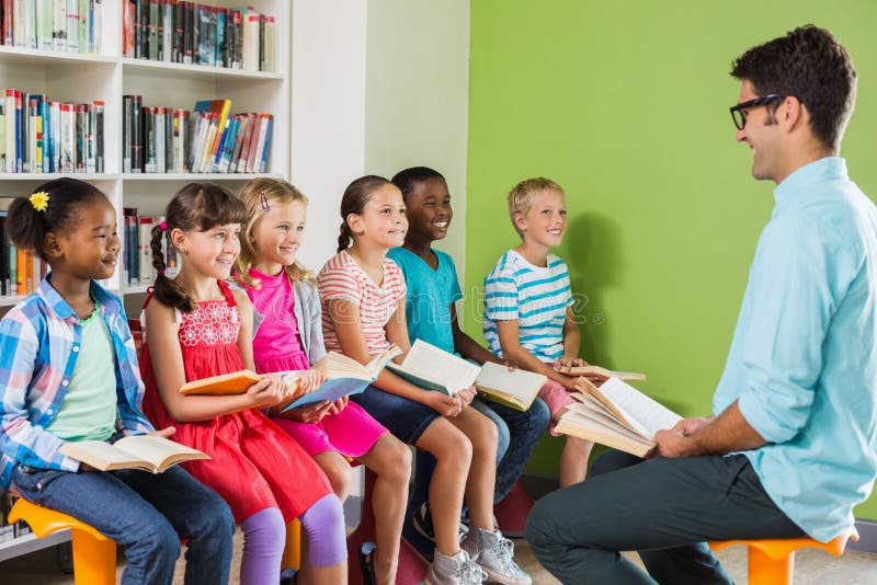 Teacher Teaching Kids in Library Stock Photo - Image of adult, academic ...