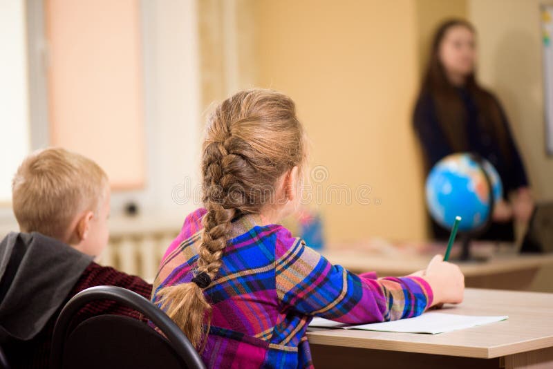 Teacher Teaching Lesson To Elementary School Pupils. Stock Image ...