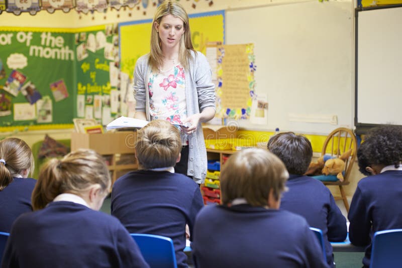 Teacher Teaching Lesson To Elementary School Pupils Stock Photo - Image ...