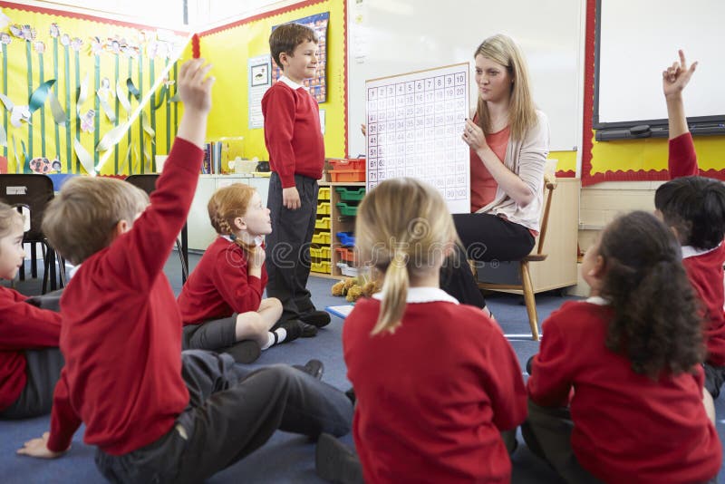 Teacher Teaching Maths To Elementary School Pupils Stock Photo - Image ...