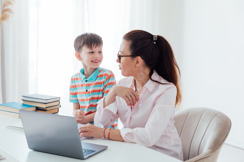Teacher Teaching Schoolboy with Laptop at Desk Stock Photo - Image of ...