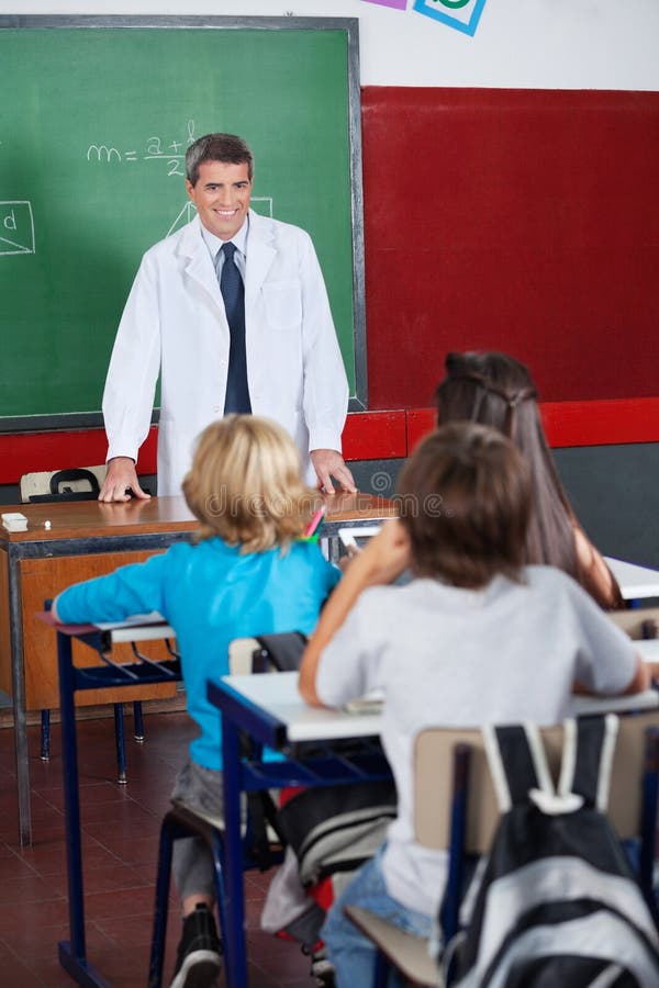 Teacher Teaching Students in Classroom Stock Photo - Image of little ...