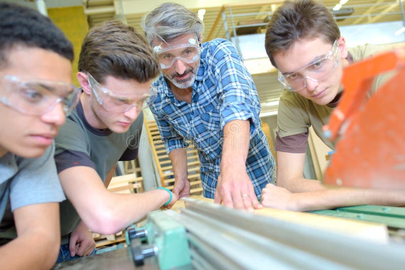 Teacher with Three Students Using Machine Stock Image - Image of work ...