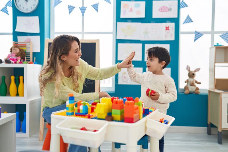 Teacher and Toddler Playing with Construction Blocks High Five at ...