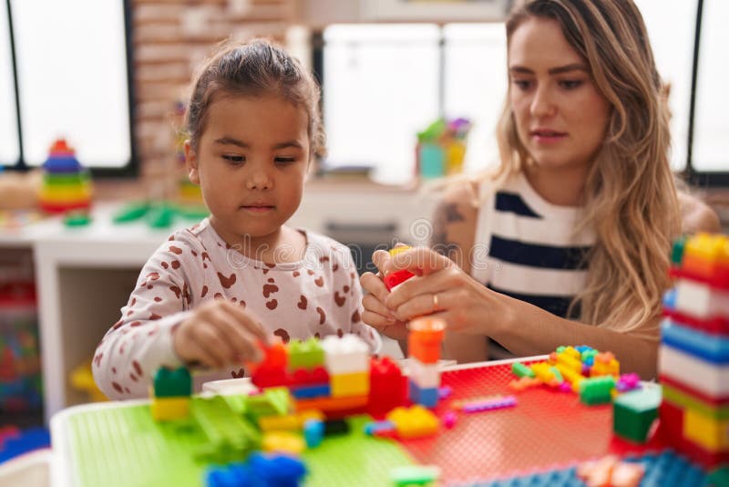 Teacher and Toddler Playing with Construction Blocks Sitting on Table ...