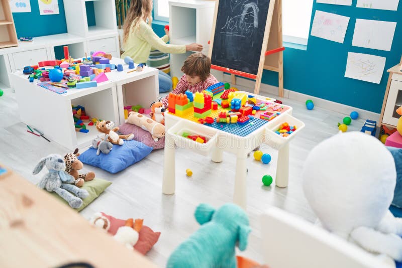 Teacher and Toddler Playing with Construction Blocks Sitting on Table ...
