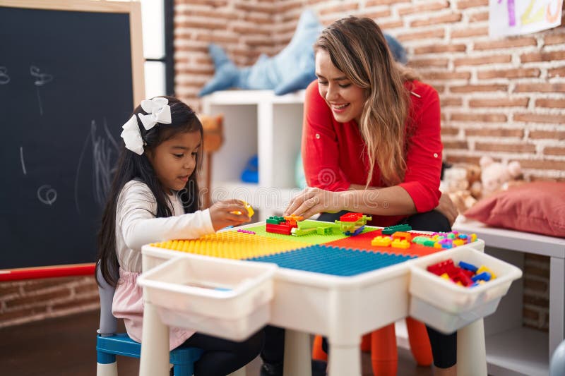 Teacher and Toddler Playing with Construction Blocks Sitting on Table ...