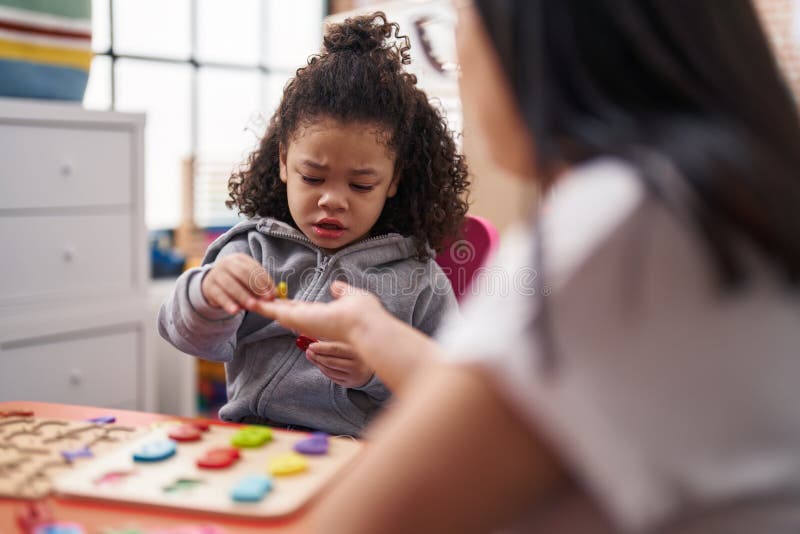 Teacher and Toddler Playing with Maths Puzzle Game Sitting on Table at ...